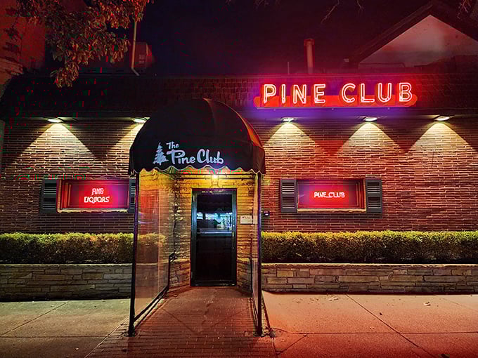 The iconic green awning and brick facade of The Pine Club stands as Dayton's temple to timeless steakhouse tradition.