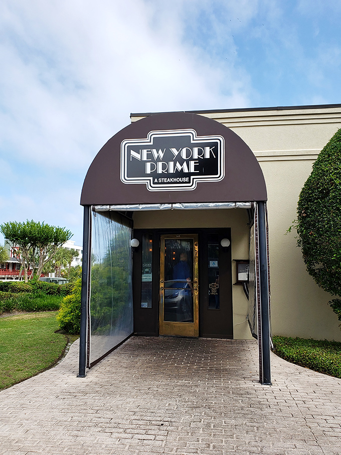 The neon glow of New York Prime beckons like a lighthouse for steak lovers&mdash;a humble exterior that belies the culinary treasures waiting inside.