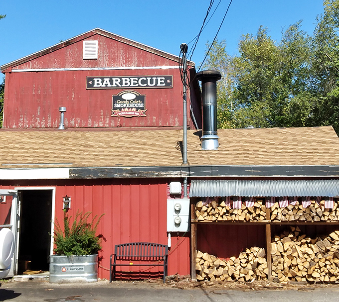 The weathered red barn exterior isn't just rustic charm—it's a smoke signal to BBQ pilgrims that authentic flavor awaits inside this New Hampshire treasure.