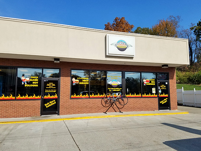The flames painted along the storefront aren't just decoration&mdash;they're a warning to your diet plans. Ridge View BBQ's exterior promises smoky delights within.