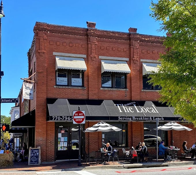The historic red brick facade of The Marietta Local stands proudly on the corner, promising comfort and community with every meal served.