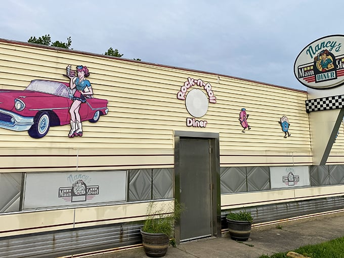 The gleaming silver exterior of Nancy's Main Street Diner stands like a time capsule on wheels, complete with vintage signage and classic car artwork.