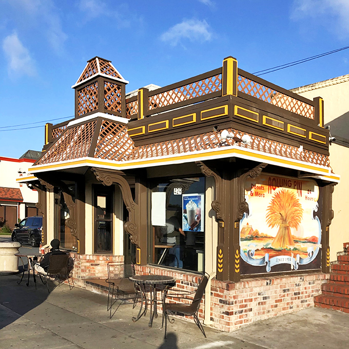 The storybook exterior of Rolling Pin Donuts stands like a beacon of sweetness on San Bruno's El Camino Real, promising delicious treasures within.