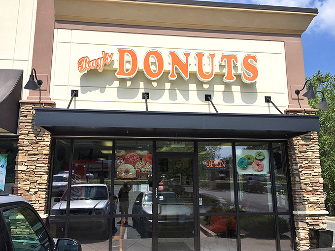 Ray's Donuts announces itself with understated confidence, its stone facade and orange lettering promising sweet treasures within like a suburban Willy Wonka factory. 