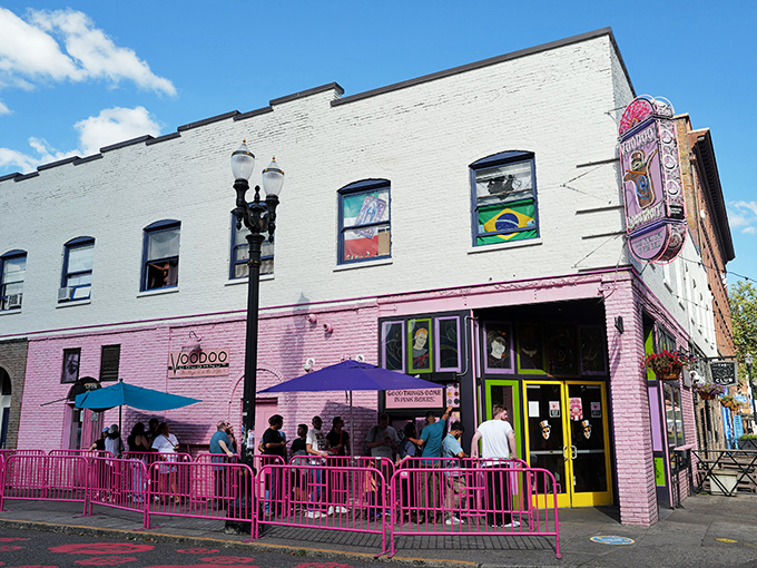 The corner where calories don't count. Voodoo Doughnut's iconic pink building stands like a sugar-powered beacon in downtown Portland, drawing pilgrims from across the globe.