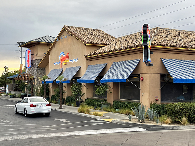 Pismo's terra cotta exterior with distinctive blue awnings stands like a coastal mirage in Fresno's urban landscape. Beach vibes without the sand in your shoes!