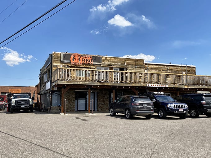 The rustic wooden exterior of Seasoned Swine BBQ beckons like a siren song to meat lovers. That deck practically begs you to enjoy your brisket with a side of Colorado sunshine.