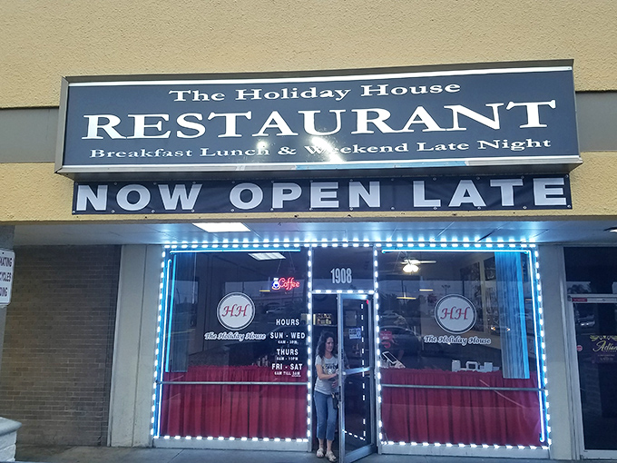 The iconic red curtains and "HH" logo welcome hungry travelers like a beacon of comfort food hope in Holiday, Florida.