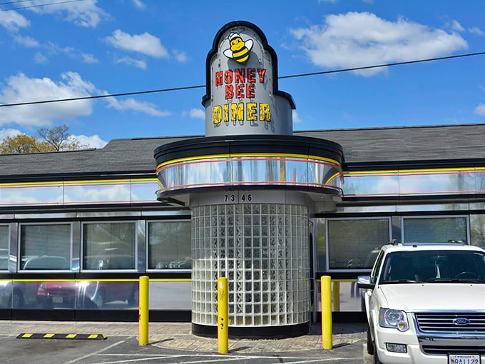 The classic mid-century silhouette of Honey Bee Diner stands proudly on Ritchie Highway, its cheerful bee mascot promising sweet comfort inside.