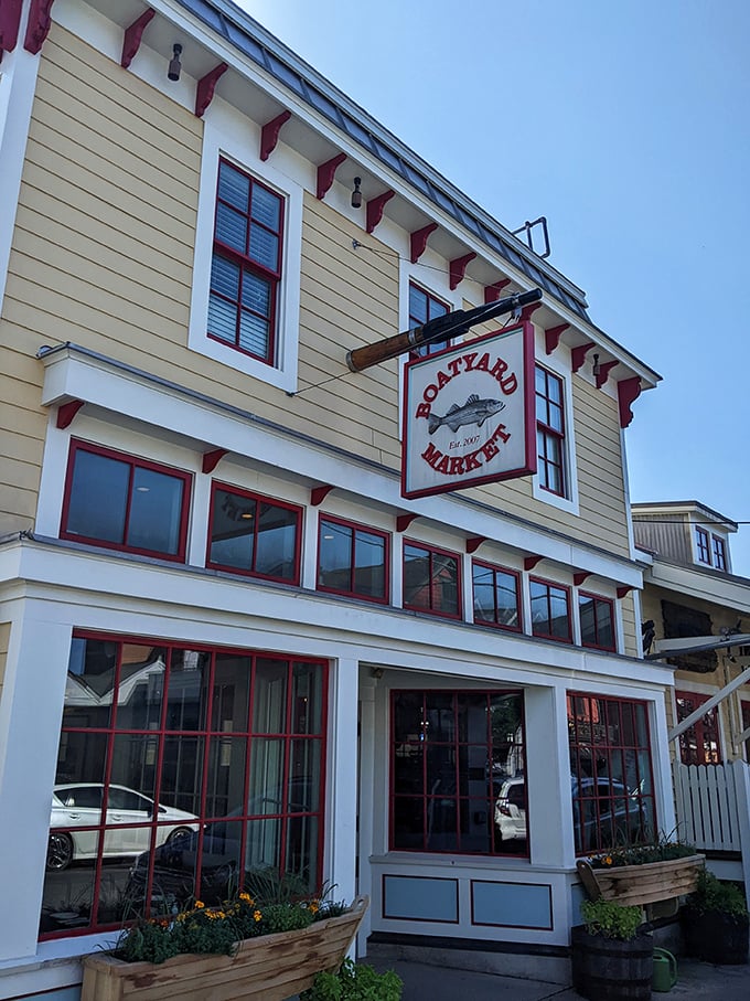 The cheerful yellow exterior of Boatyard Bar & Grill stands like a beacon for seafood lovers, promising maritime delights within its nautical embrace.