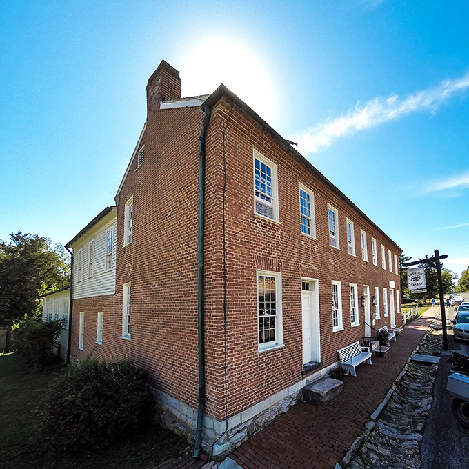 The historic red brick exterior of J. Huston Tavern stands proudly in Arrow Rock, a time capsule of frontier hospitality since 1834.