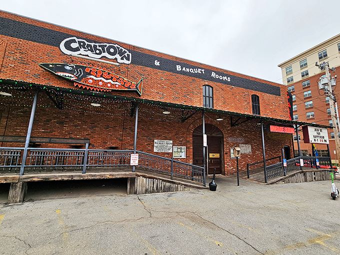 The iconic red neon "CRATOWN" sign beckons hungry travelers like a lighthouse for landlocked seafood lovers in Oklahoma City's Bricktown district.