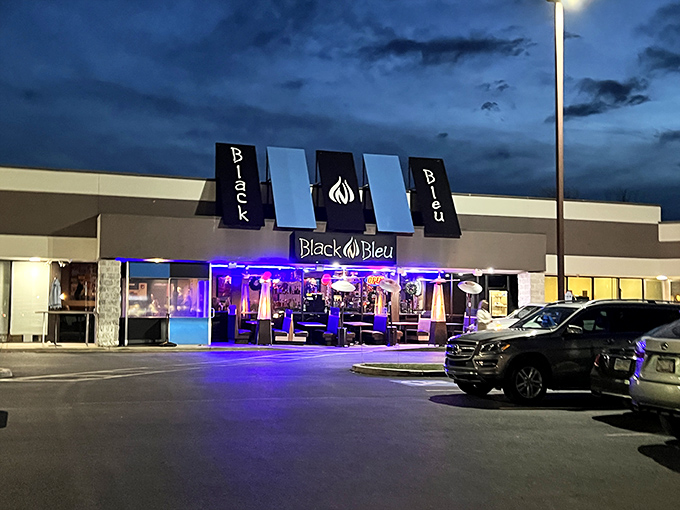 The blue glow of Black n Bleu's facade beckons hungry travelers like a culinary lighthouse in Mechanicsburg's evening landscape.
