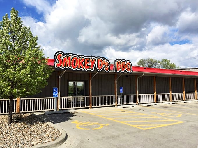 The bright red sign of Smokey D's BBQ stands as a beacon of hope for hungry travelers. Simple exterior, extraordinary flavors waiting inside.