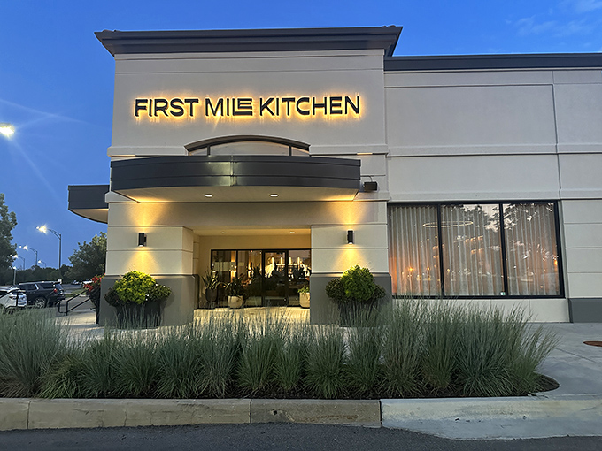 First Mile Kitchen's illuminated sign beckons hungry travelers like a culinary lighthouse in Wichita's Bradley Fair shopping district.