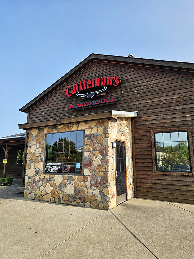 The rustic wooden exterior of Cattleman's Roadhouse beckons like an old friend, promising comfort and satisfaction within those stone-accented walls.