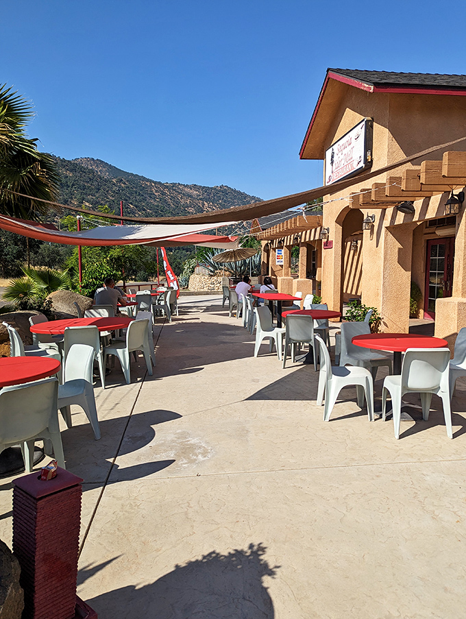 The stucco exterior with its distinctive red tables whispers "nothing fancy here" &ndash; but that's exactly what makes this Three Rivers gem so special.