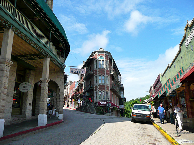 Downtown Eureka Springs curves like a Victorian dream, where red brick buildings and historic hotels create a postcard-perfect scene that defies modern architectural monotony.