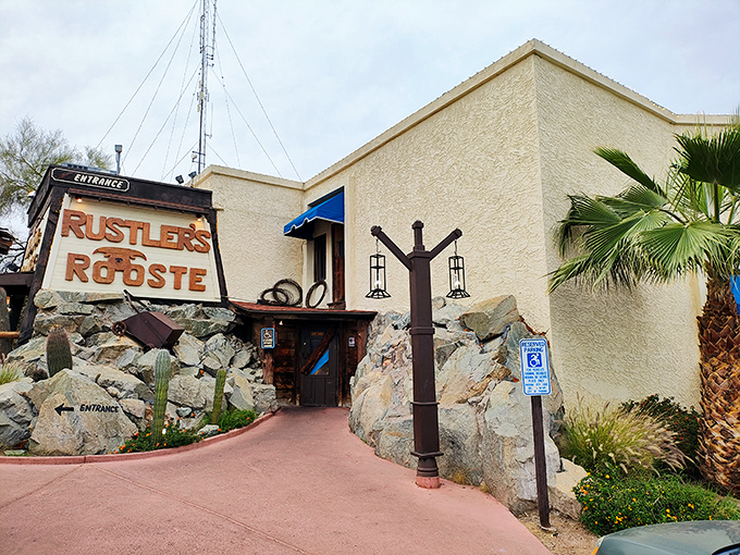 The welcoming facade of Rustler's Rooste stands proud against the Arizona sky, where blue awnings and red tablecloths hint at the Western hospitality waiting inside.
