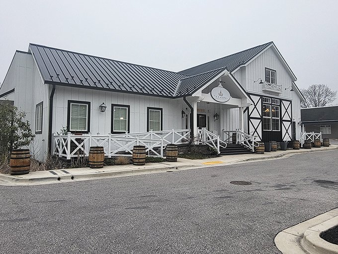 The white farmhouse exterior promises culinary magic within, like finding a surprise gift wrapped in architectural charm.