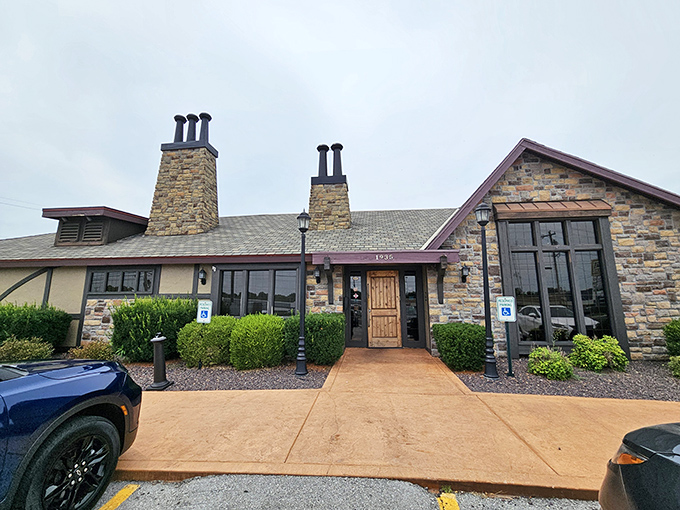 The stone facade of Jimm's stands proudly like a carnivore's castle, promising meaty treasures within. Even the shrubs look well-fed and happy.