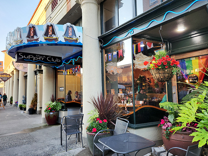 The blue awning with sailing ships beckons like a lighthouse for hungry souls. Astoria's historic charm meets culinary adventure at T. Paul's entrance.