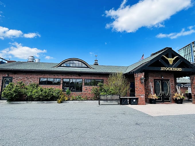 The grand entrance beckons with its iconic golden longhorn skull, promising carnivorous delights within those brick walls. Massachusetts hospitality with a Texas accent.