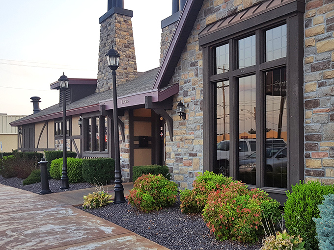 The stone facade of Jimm's stands proudly like a carnivore's castle, promising meaty treasures within. Even the shrubs look well-fed and happy.