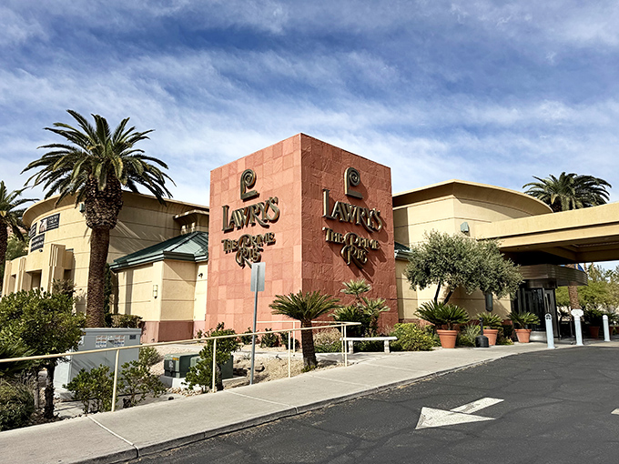 The unassuming exterior of Lawry's The Prime Rib stands like a calm oasis amid Vegas's neon storms. Palm trees welcome you to this temple of meat.