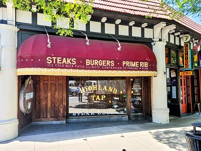 The entrance to Highland Tap beckons like a speakeasy from another era. Stone walls and that iconic burgundy awning promise carnivorous delights below street level.