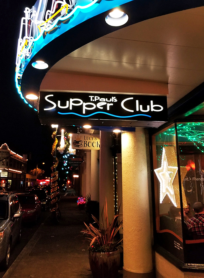 The blue awning with sailing ships beckons like a lighthouse for hungry souls. Astoria's historic charm meets culinary adventure at T. Paul's entrance.