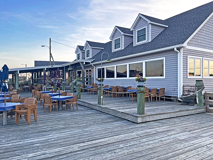 The quintessential coastal dining experience awaits at JP's on the Wharf, where weathered wood decking and blue umbrellas set the stage for waterfront magic.