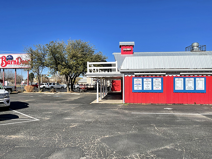 The iconic red barn facade beckons hungry travelers like a carnivorous lighthouse guiding you to beef paradise.