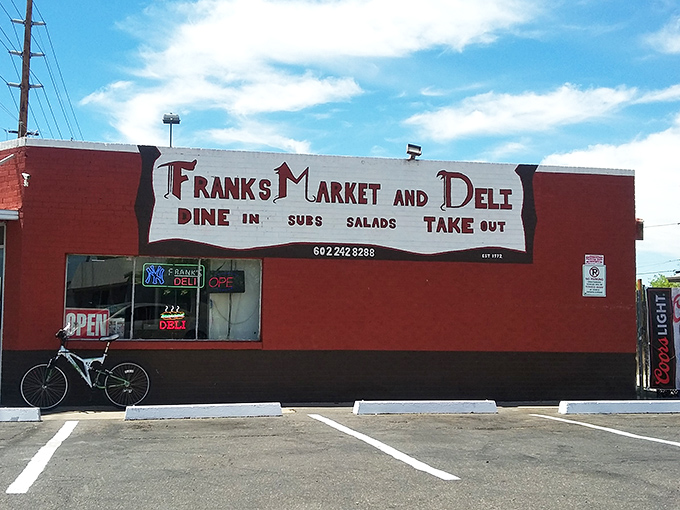 The bright red exterior of Frank's Market and Deli stands like a culinary lighthouse in Phoenix, beckoning sandwich enthusiasts from miles around.