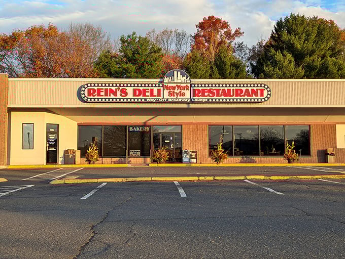 The iconic Rein's Deli sign glows like a Broadway marquee in Connecticut, promising New York flavors without the traffic or attitude. 