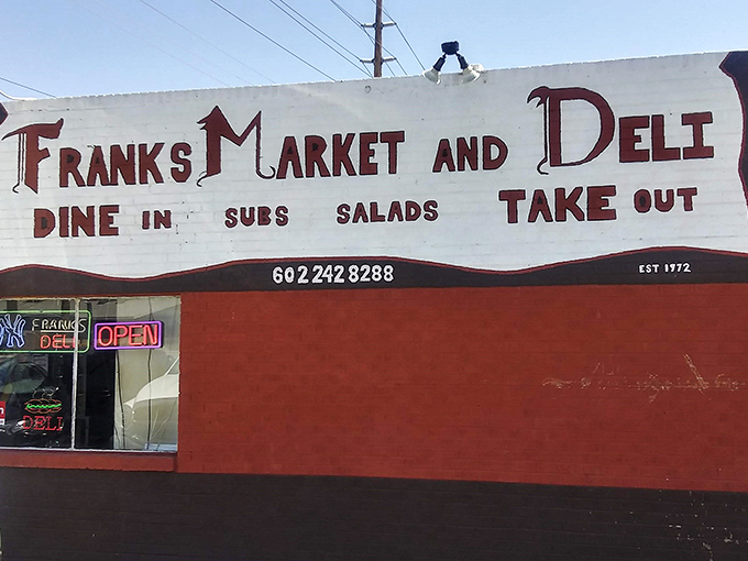 The bright red exterior of Frank's Market and Deli stands like a culinary lighthouse in Phoenix, beckoning sandwich enthusiasts from miles around.