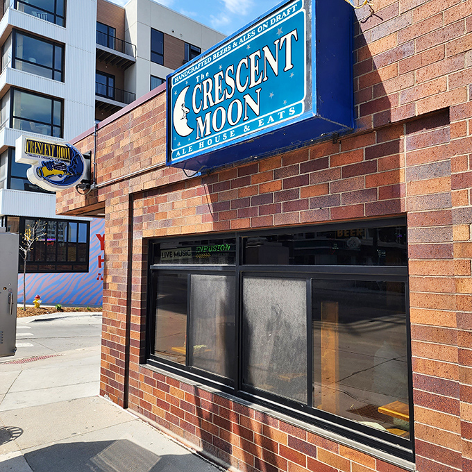 The iconic blue crescent moon entrance beckons like a portal to comfort food nirvana. Brick, beer, and the promise of Nebraska's best Reuben await.