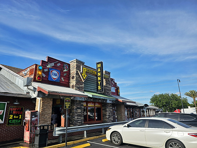The neon-lit exterior of Manny's Original Chophouse stands like a beacon for carnivores, promising "LOVE at First Bite" beneath its iconic signage.