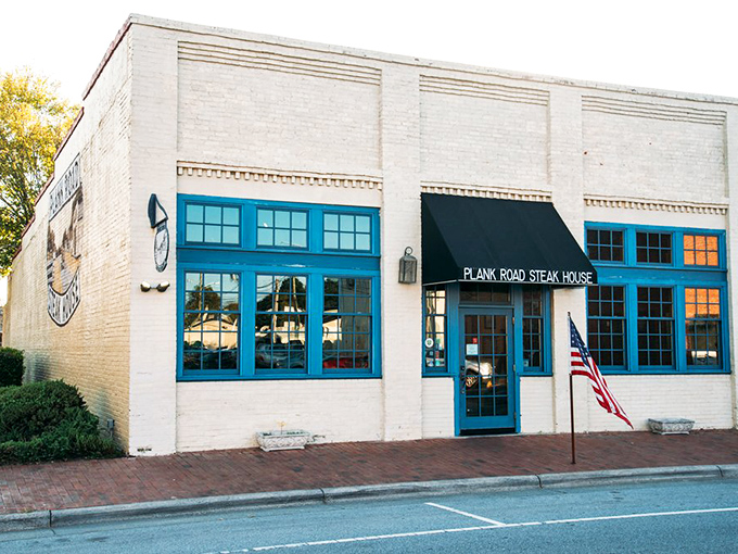 The unassuming yellow brick exterior of Plank Road Steak House hides culinary treasures within, like a delicious secret waiting to be discovered. 