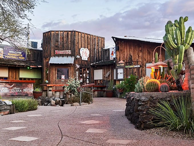 The Horny Toad's weathered wooden exterior stands like a time capsule of the Wild West, complete with saguaro sentinels guarding desert-worn pathways.