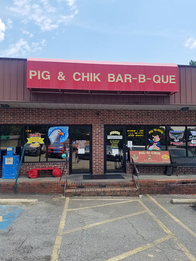 The bright red sign beckons like a barbecue lighthouse in a sea of hunger. No fancy frills here&mdash;just the promise of smoky delights waiting inside.