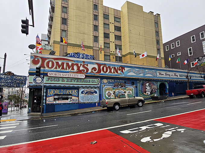 The unmistakable blue exterior of Tommy's Joynt stands like a colorful time capsule on Van Ness Avenue, complete with international flags and hand-painted promises of culinary delights within.