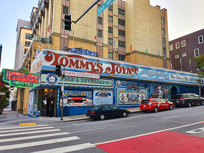 The unmistakable blue exterior of Tommy's Joynt stands like a colorful time capsule on Van Ness Avenue, complete with international flags and hand-painted promises of culinary delights within.