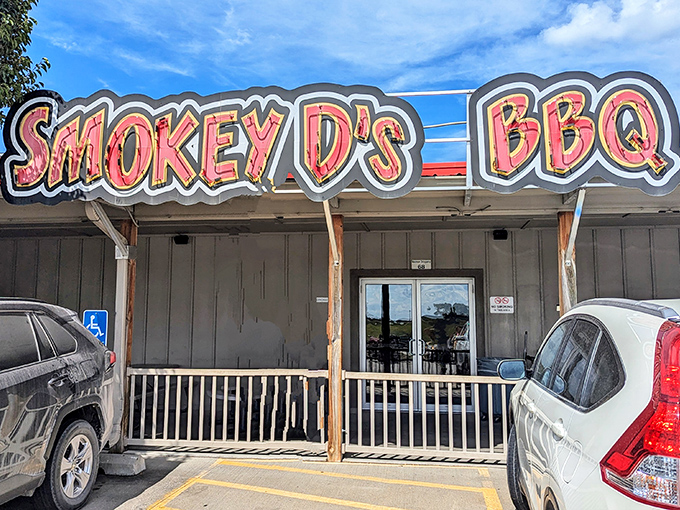 The bright red sign of Smokey D's BBQ stands as a beacon of hope for hungry travelers. Simple exterior, extraordinary flavors waiting inside.