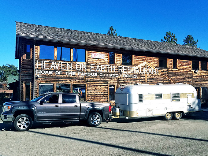 The rustic log cabin exterior of Heaven on Earth Restaurant stands as a beacon for hungry travelers on I-5, promising comfort food salvation in Azalea.