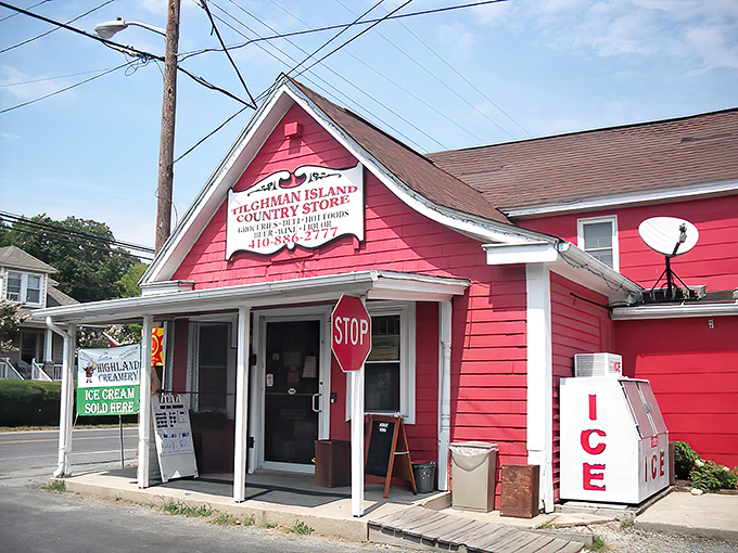 The cherry-red clapboard exterior of Tilghman Island Country Store stands like a beacon of hope for hungry travelers, promising culinary treasures within its humble walls.