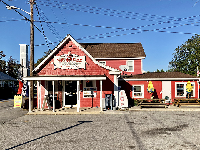 The cherry-red clapboard exterior of Tilghman Island Country Store stands like a beacon of hope for hungry travelers, promising culinary treasures within its humble walls.