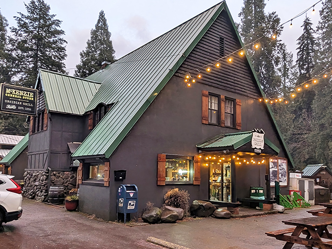Twilight transforms this charming A-frame into a beacon for hungry travelers. String lights twinkle like fireflies against the green metal roof.