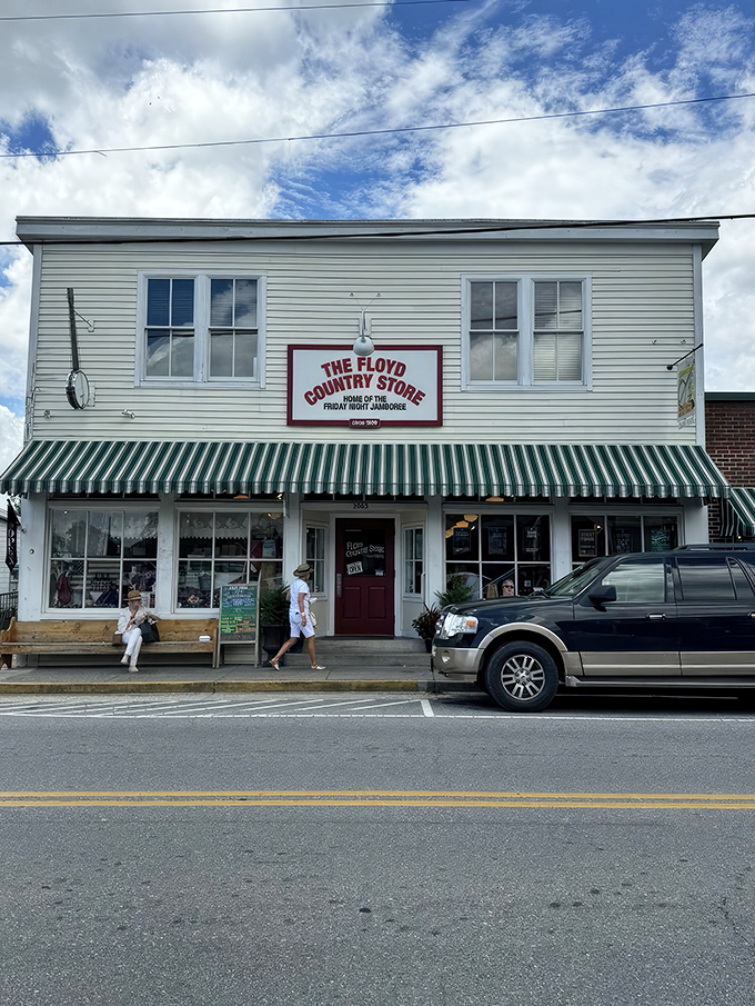 The classic white clapboard exterior of Floyd Country Store stands as a beacon of Appalachian charm, complete with that iconic green-striped awning that practically whispers, "Come on in, y'all."