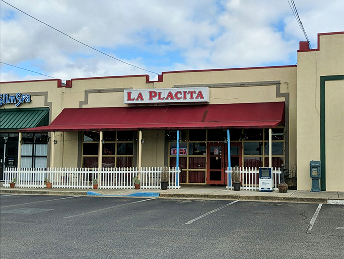 La Placita's cheerful exterior beckons with its bright yellow walls and red awning&mdash;like a sunset wrapped around a building that promises culinary adventure inside.